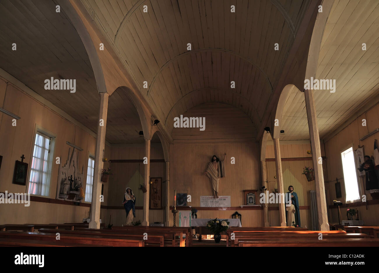 Natural light view of wooden church interior, with pews effigies Easter ...