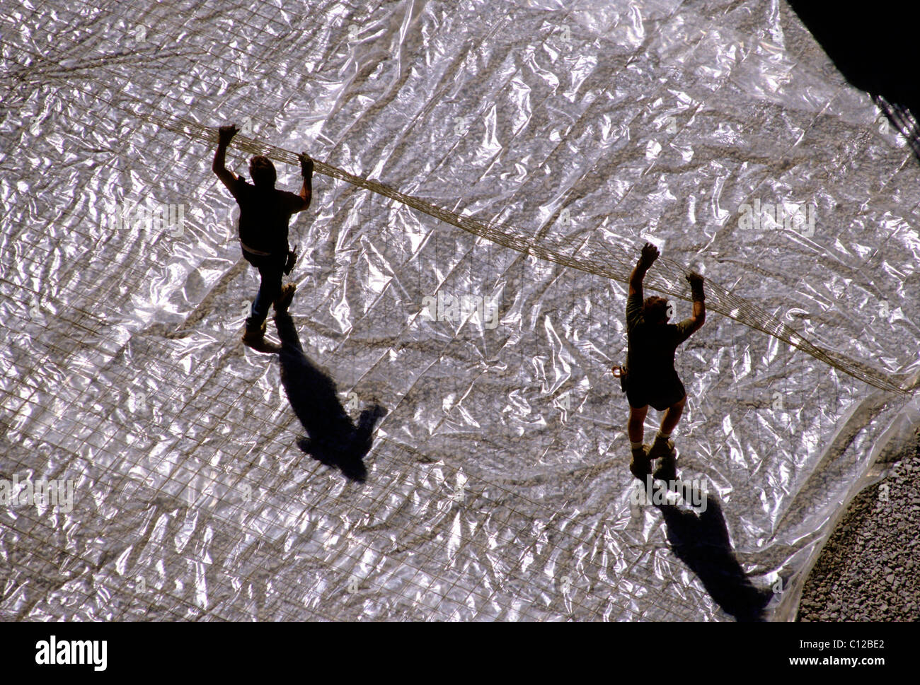 Construction workers position reinforcing bar at a commercial building ...