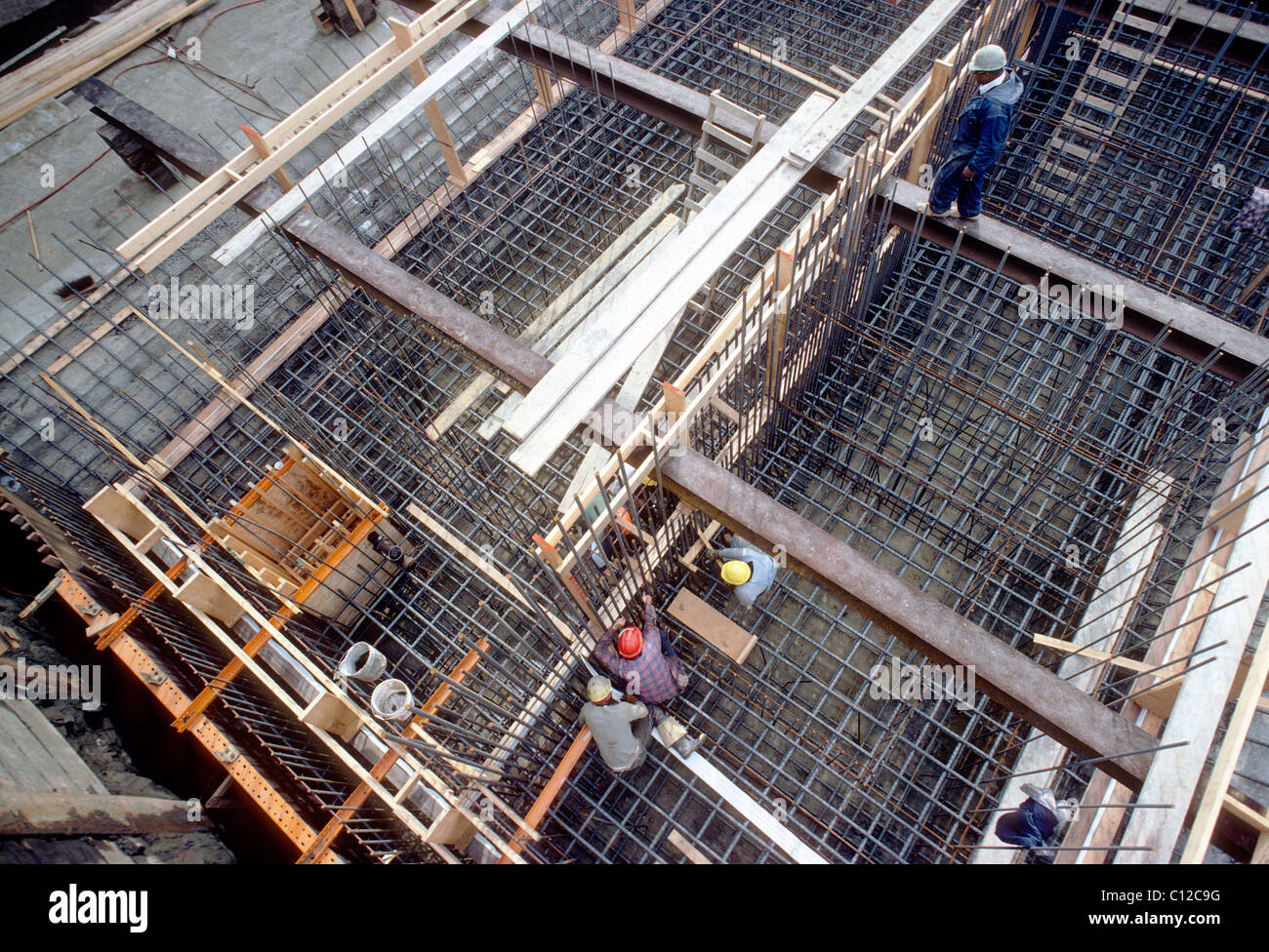 Construction workers position reinforcing bar in preparation for cement ...