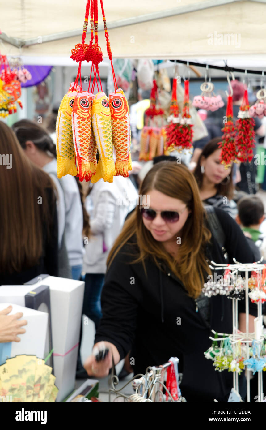 Shoppers browse a booth of Japanese items at the Matsuri Festival in ...