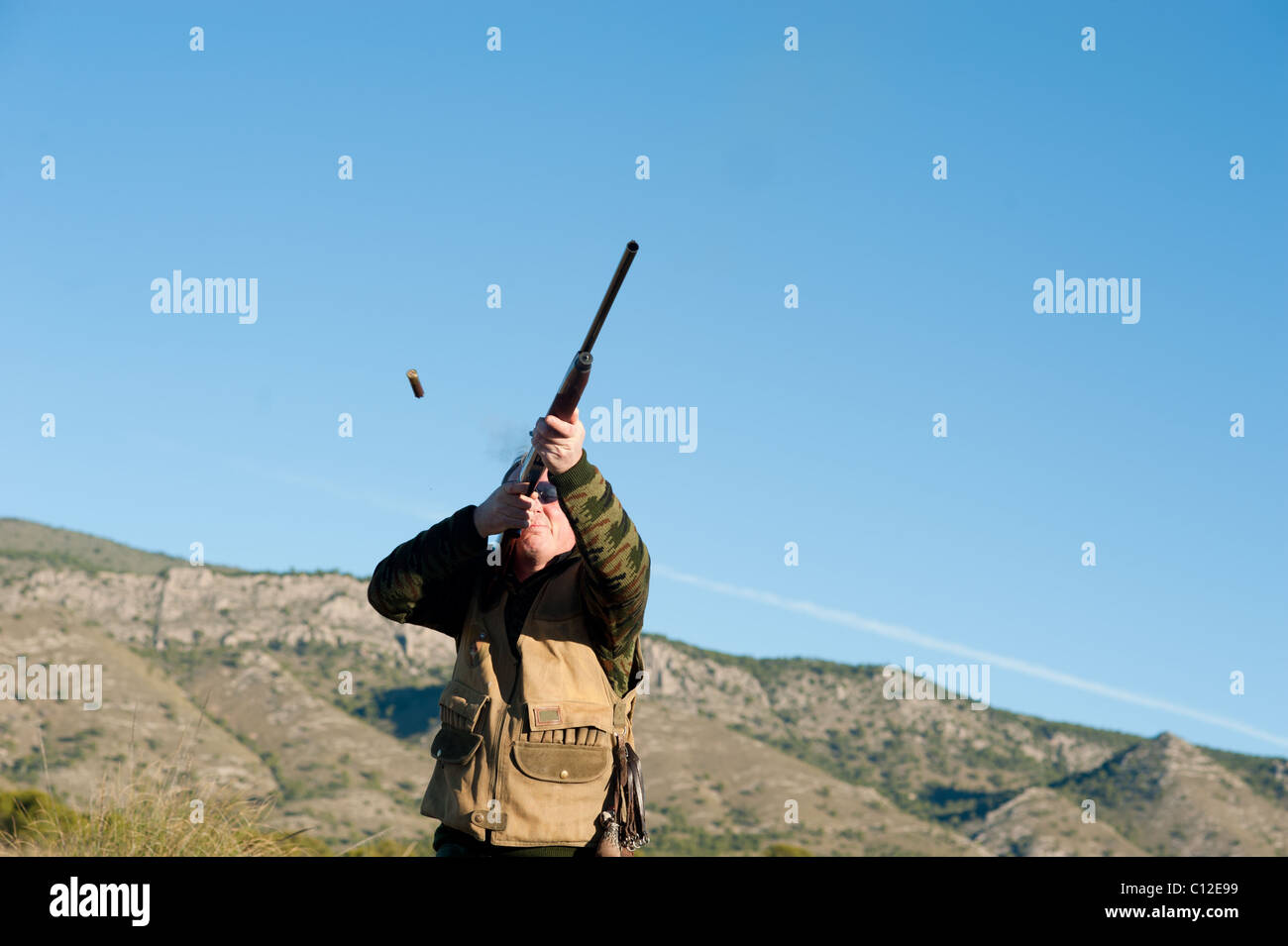 Hunter in action aiming and shooting his rifle Stock Photo - Alamy