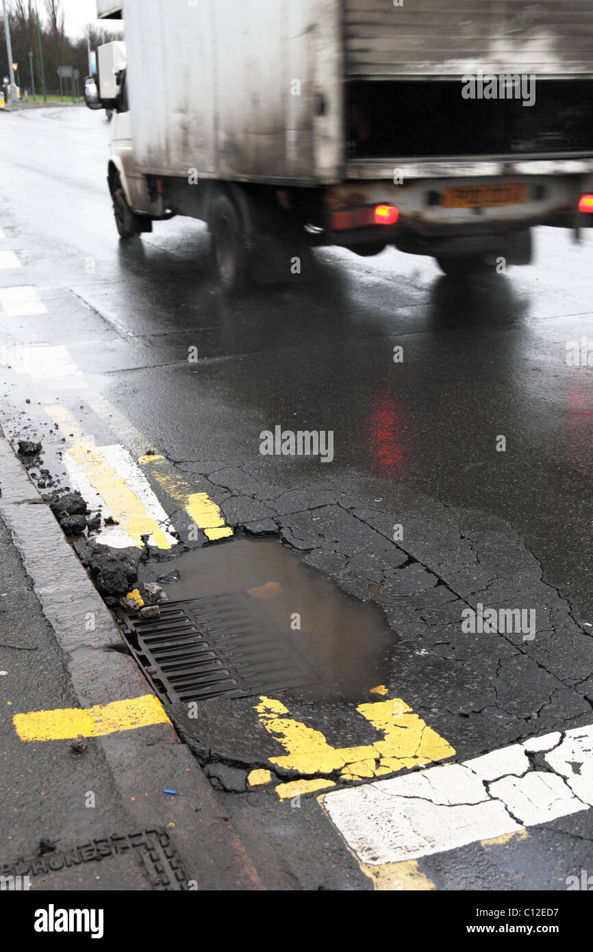 Potholes on a road in a U.K. city Stock Photo - Alamy
