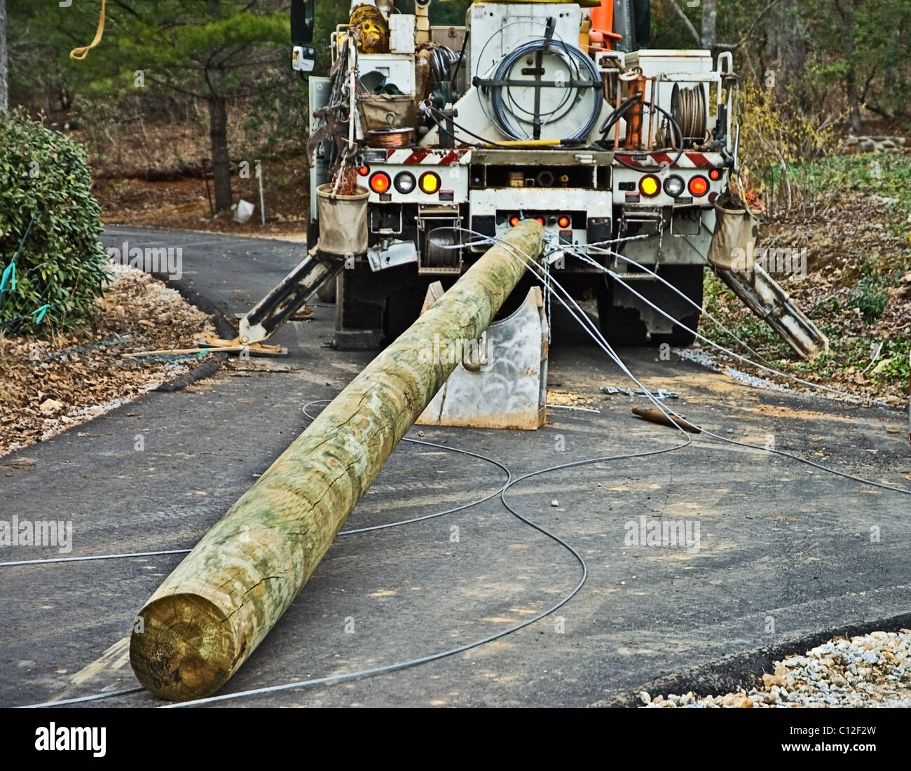 Wires being connected to a new utility pole to replace one damaged ...
