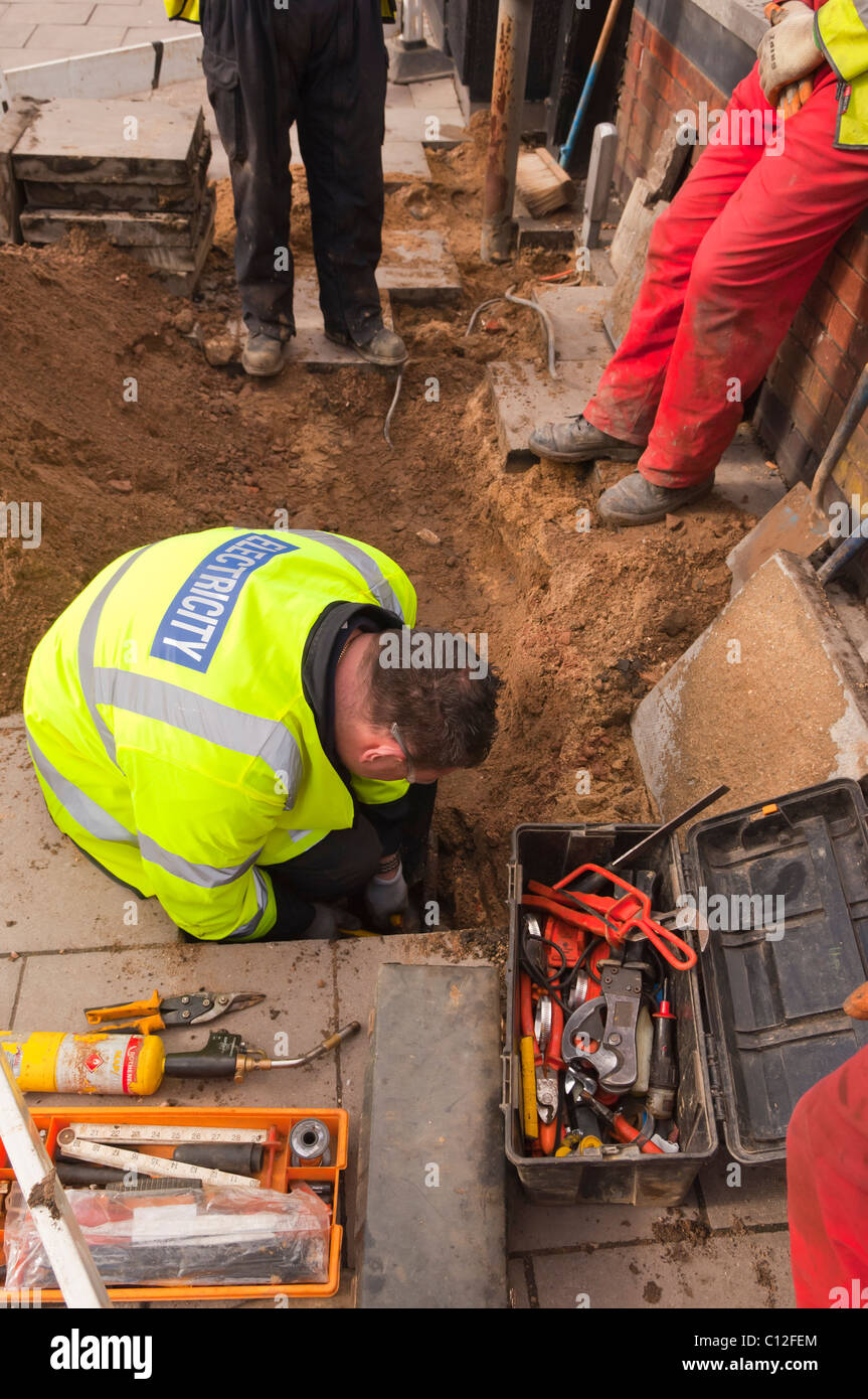 A worker from the electricity board works on underground cables in the ...