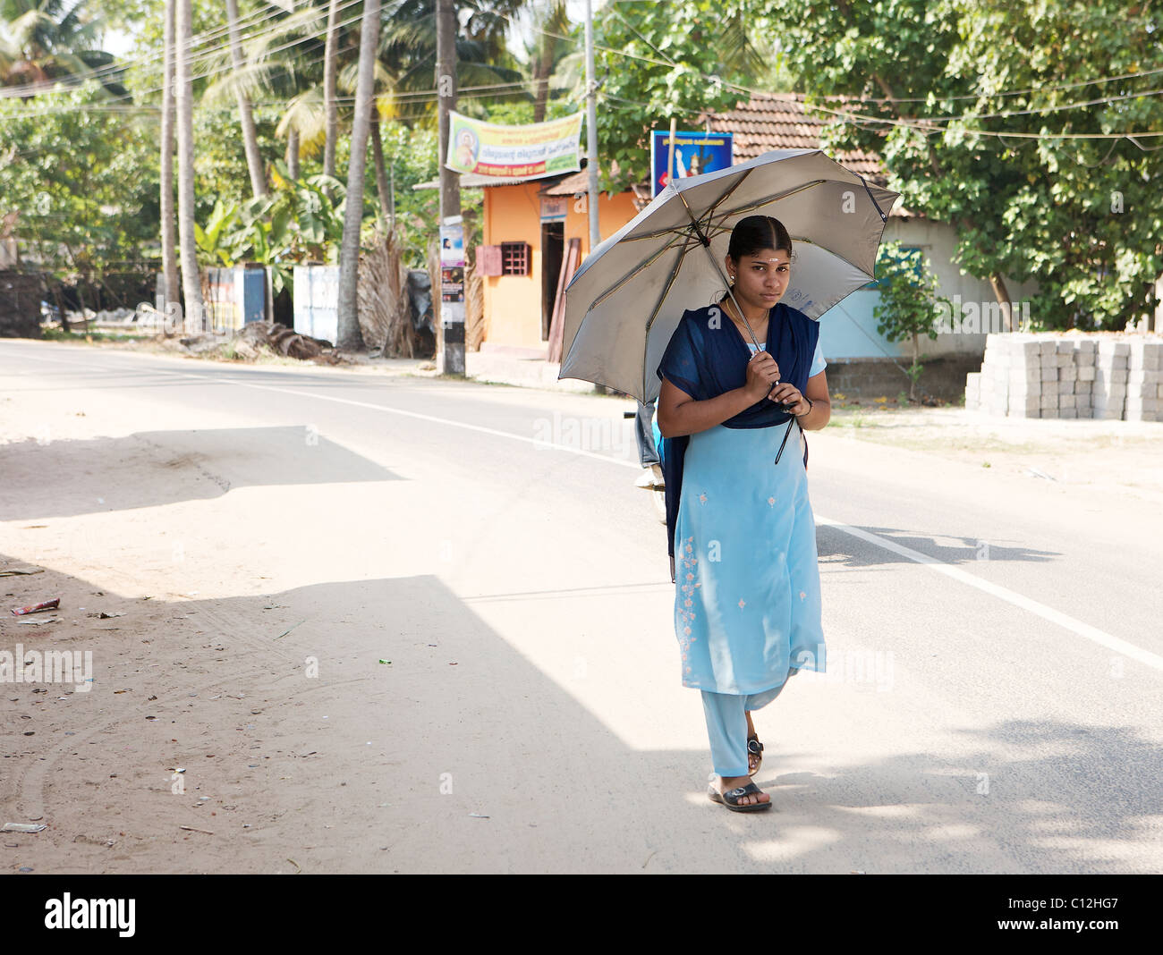 A Keralite woman shades herself from the midday sun in a village south ...