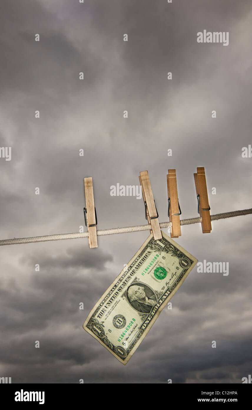 USA, New Jersey, Jersey City, One dollar banknote drying on clothline ...
