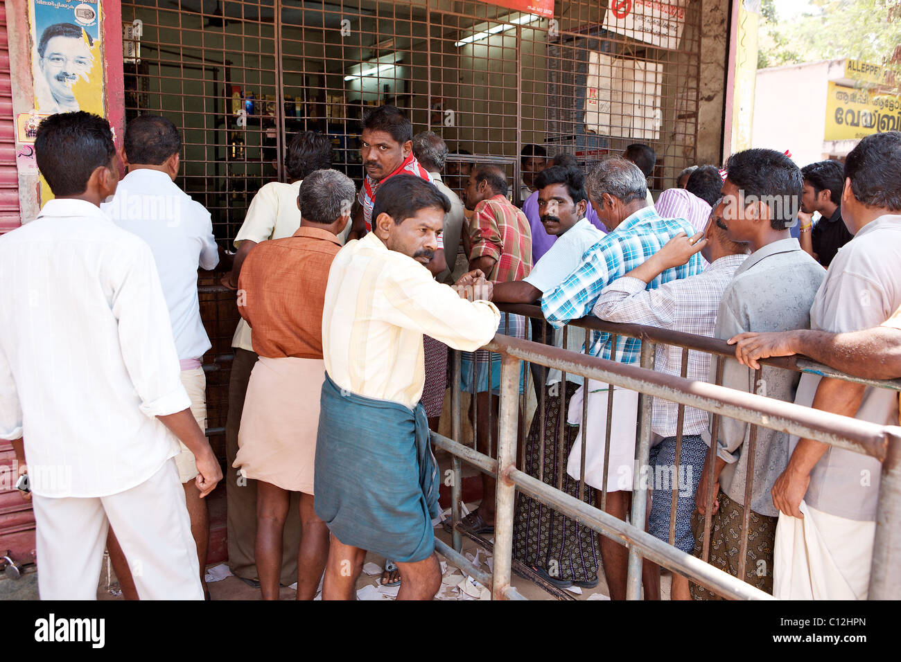 Men queue to buy alcohol from government-contolled outlet in a village ...