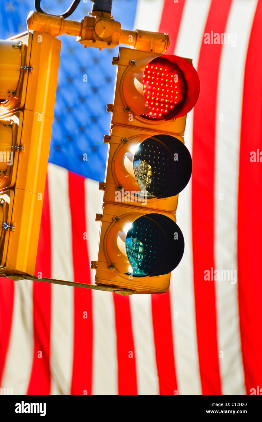 USA, New York City, Traffic lights with american flag in background ...