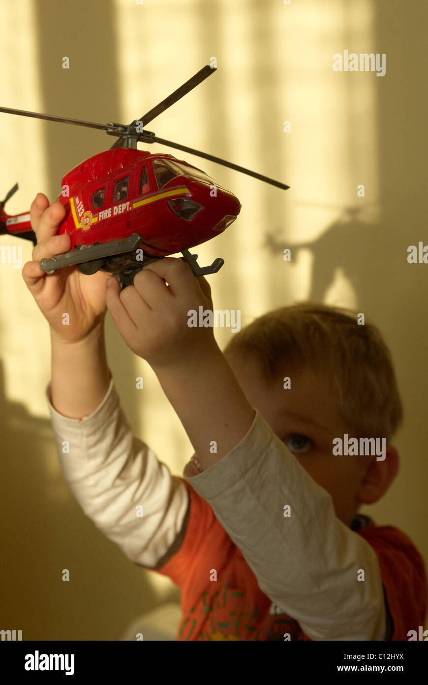 A Young Boy Playing with a Toy Helicopter Stock Photo - Alamy