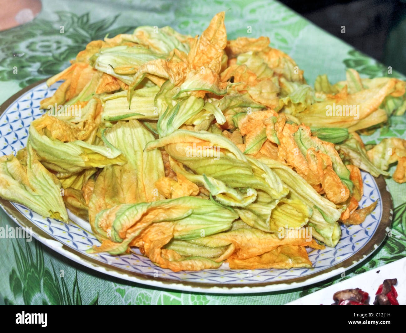 patterned cloth with plate of delicious fresh squash flowers ready to be used in Oaxacan cooking ...