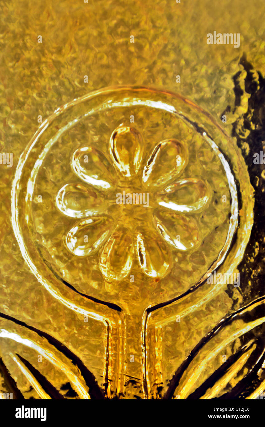 Yellow flower on stained glass and light reflections abstract ...