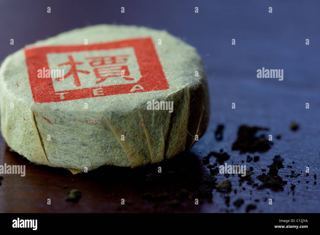 A tablet of Chinese black tea with some tea leaves Stock Photo - Alamy