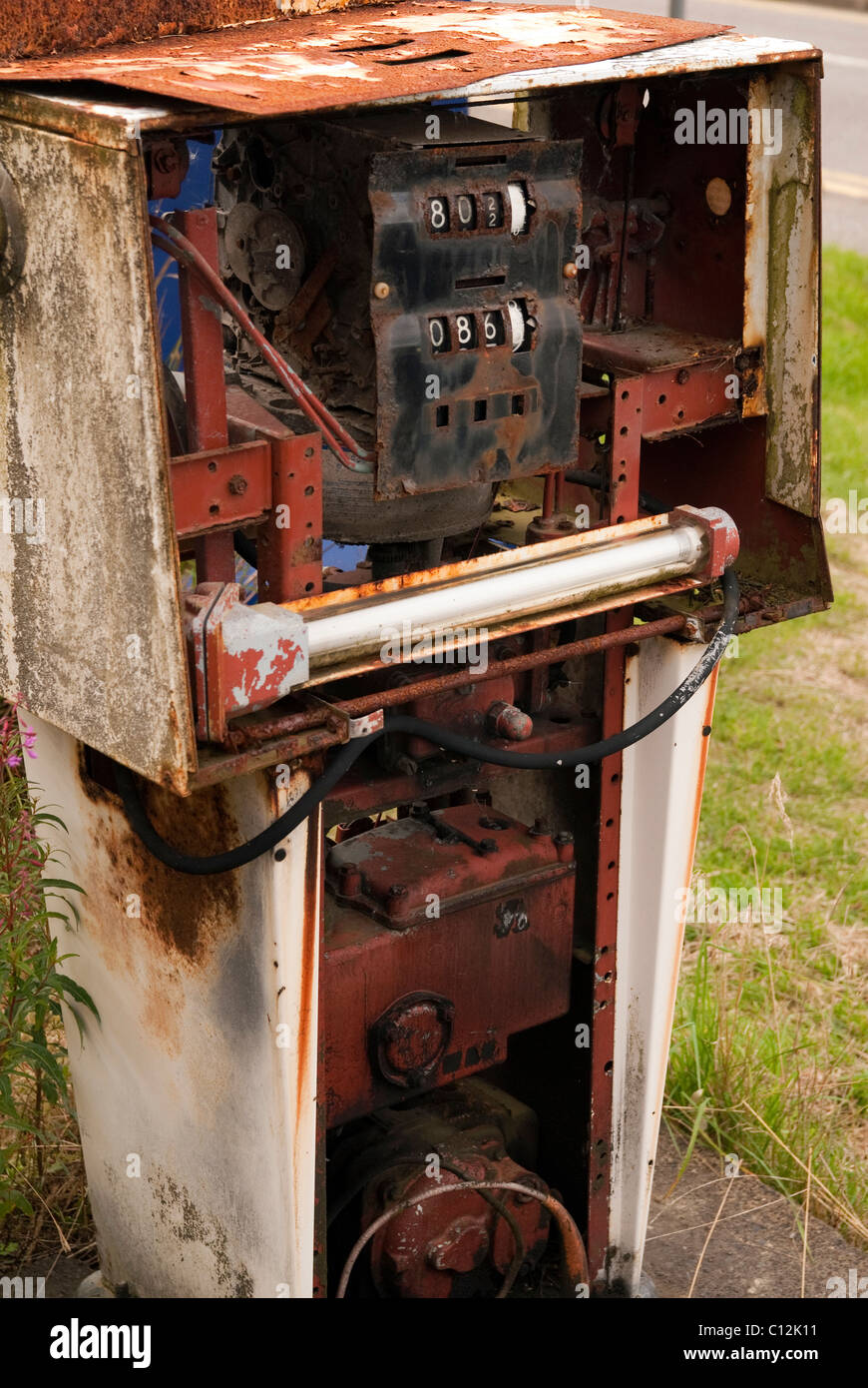 Rusty / derelict old petrol / gas pump at a dissused filling station ...