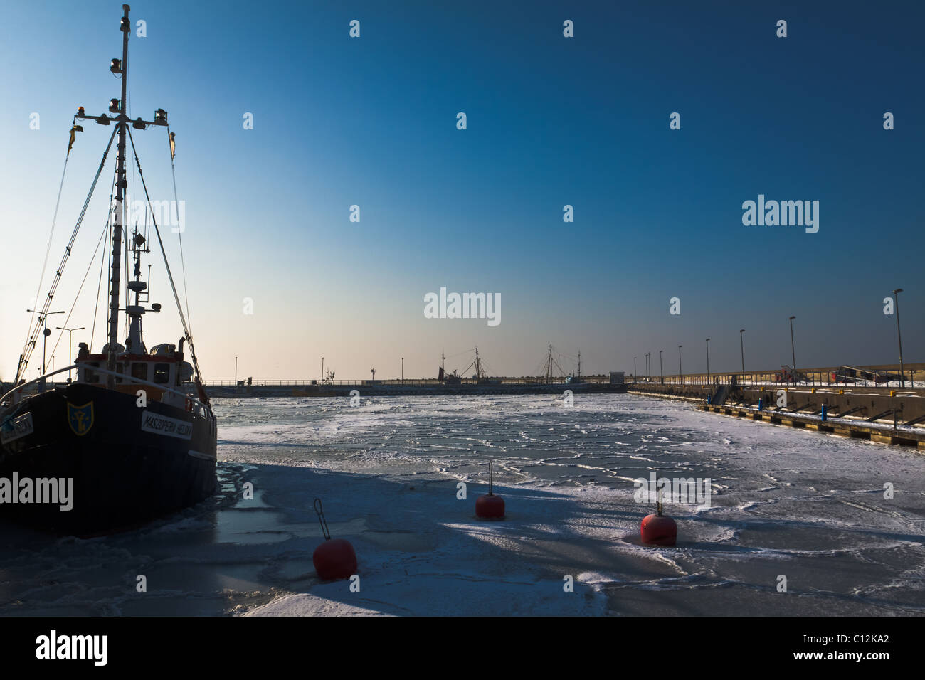 Winter sunrise in frozen harbor Stock Photo - Alamy