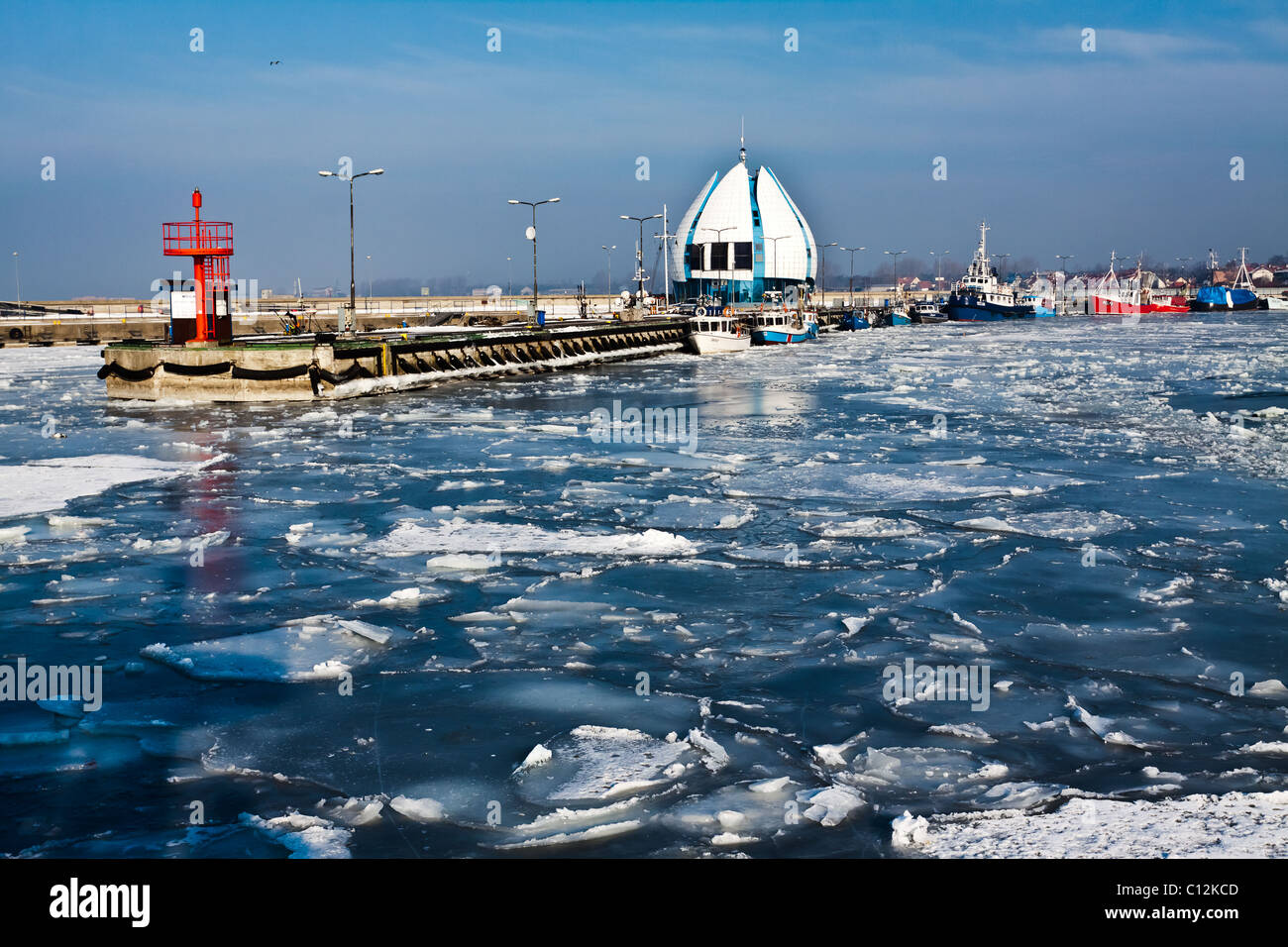 Winter sunrise in frozen harbor Stock Photo - Alamy
