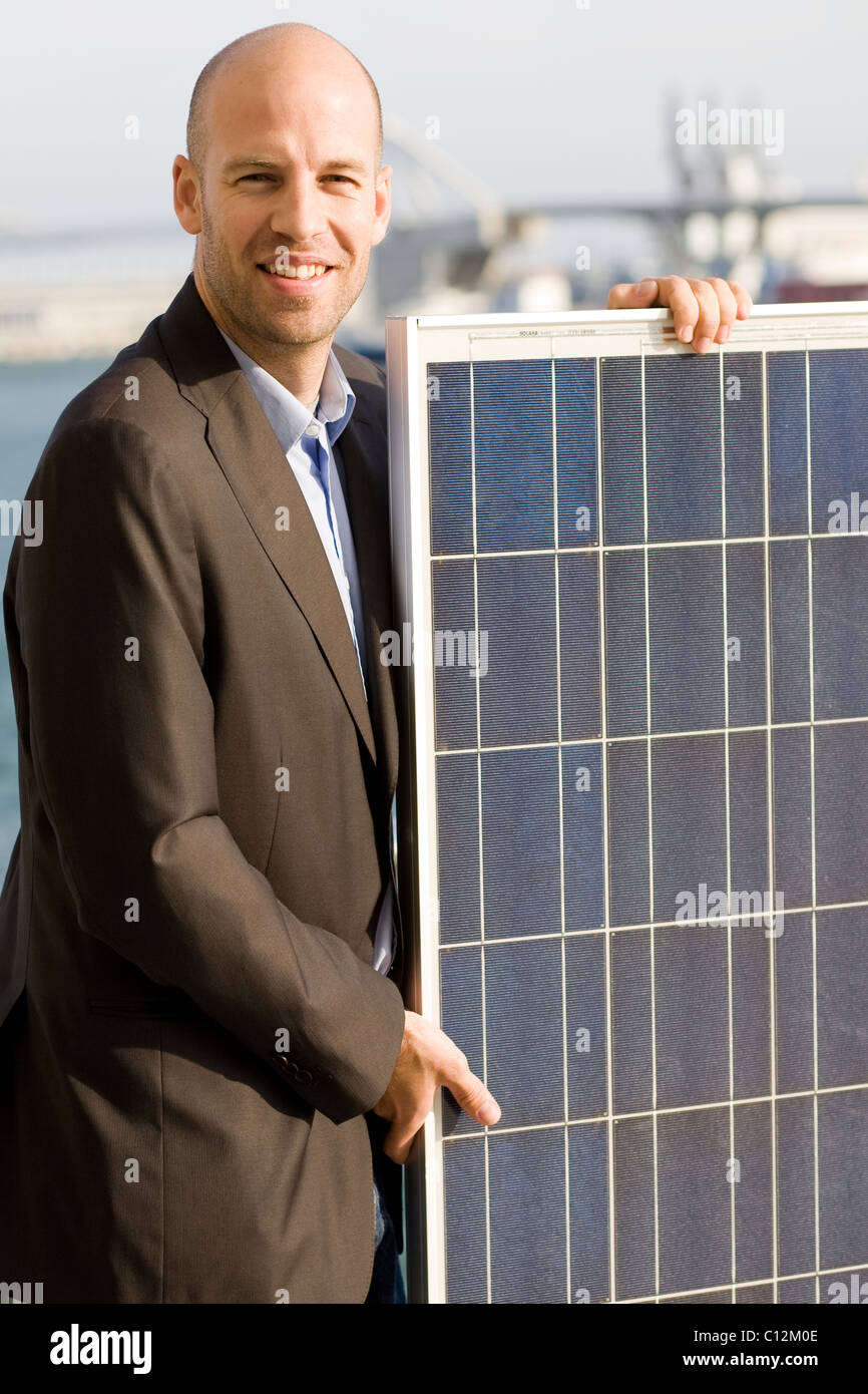 Renawable energy business man with a solar panel Stock Photo - Alamy