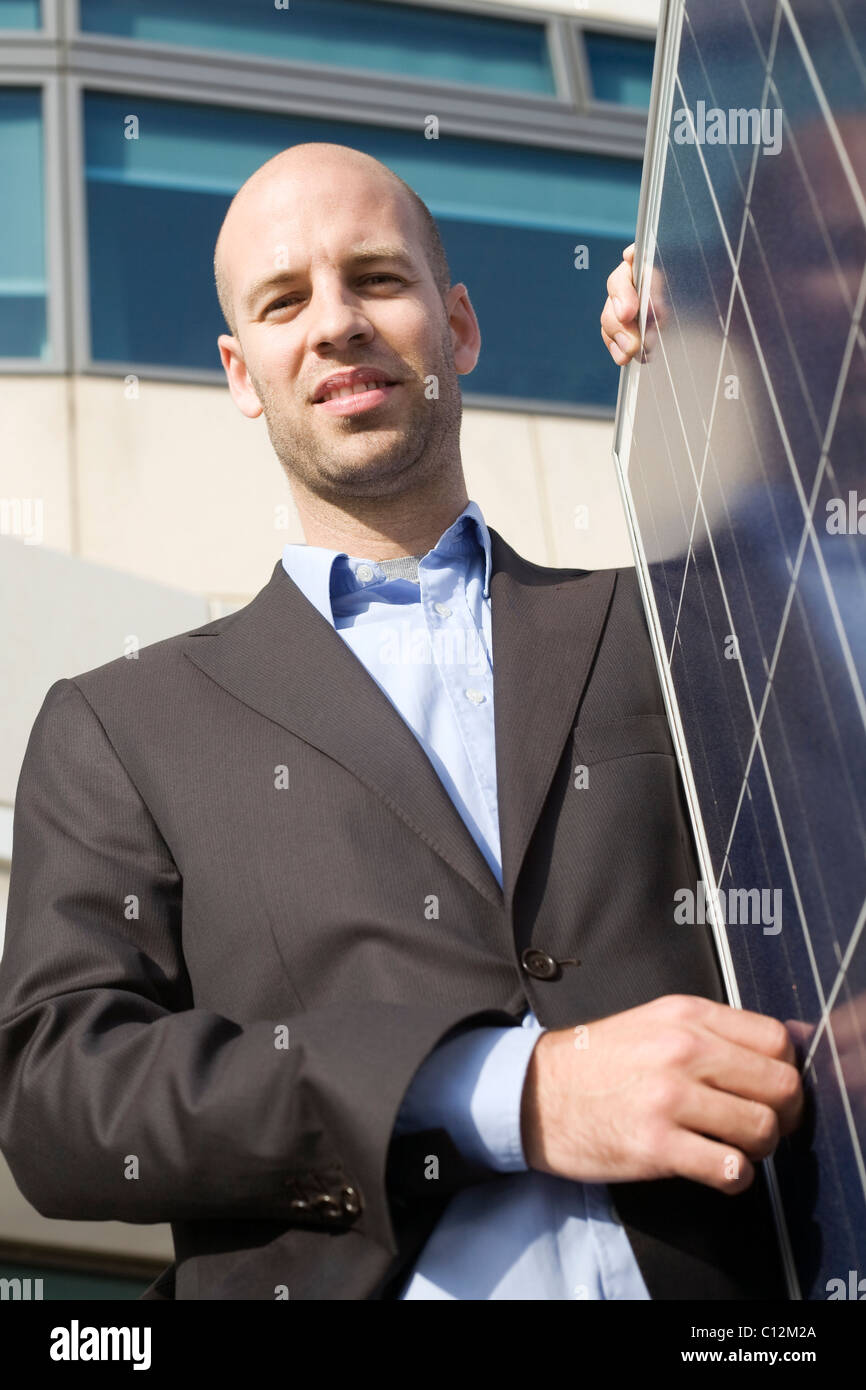 Renawable energy business man with a solar panel Stock Photo - Alamy