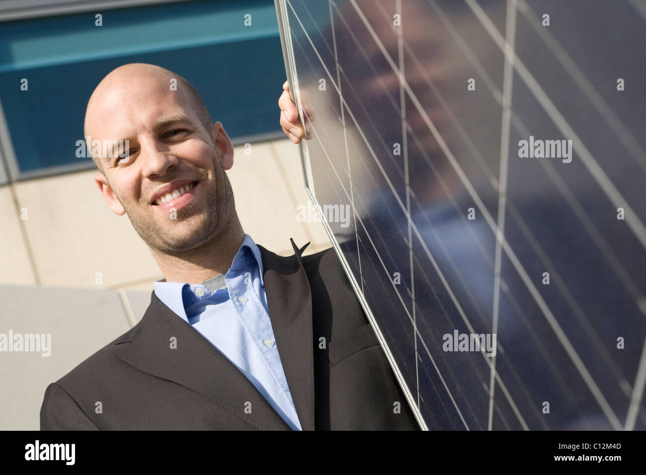 Renawable energy business man with a solar panel Stock Photo - Alamy