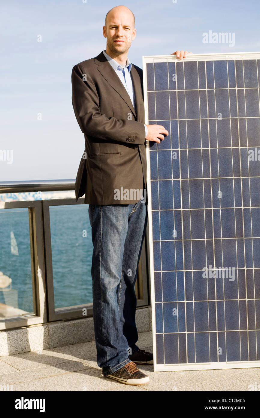 Solar energy man with a solar panel Stock Photo - Alamy