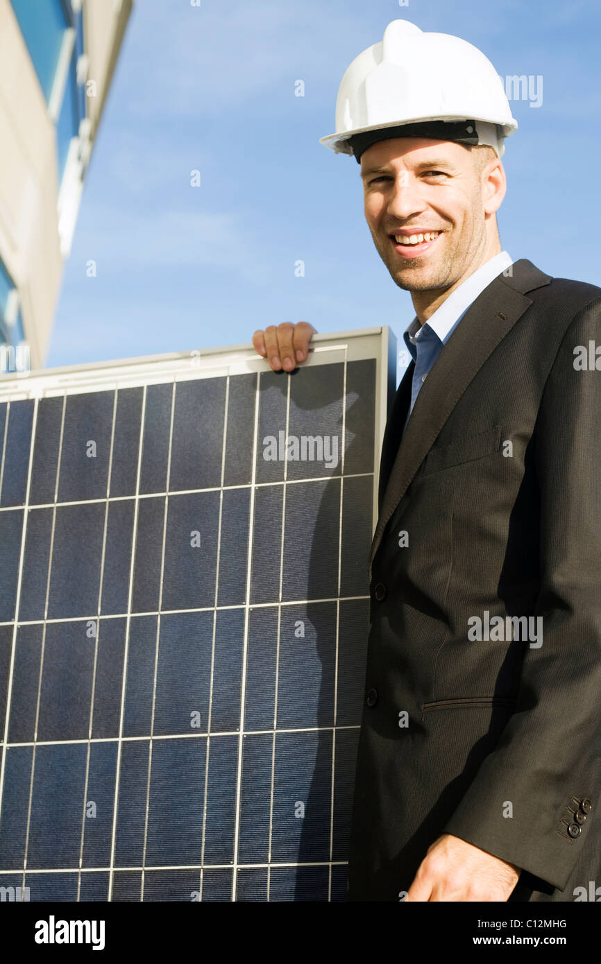 Renawable energy business man with a solar panel Stock Photo - Alamy