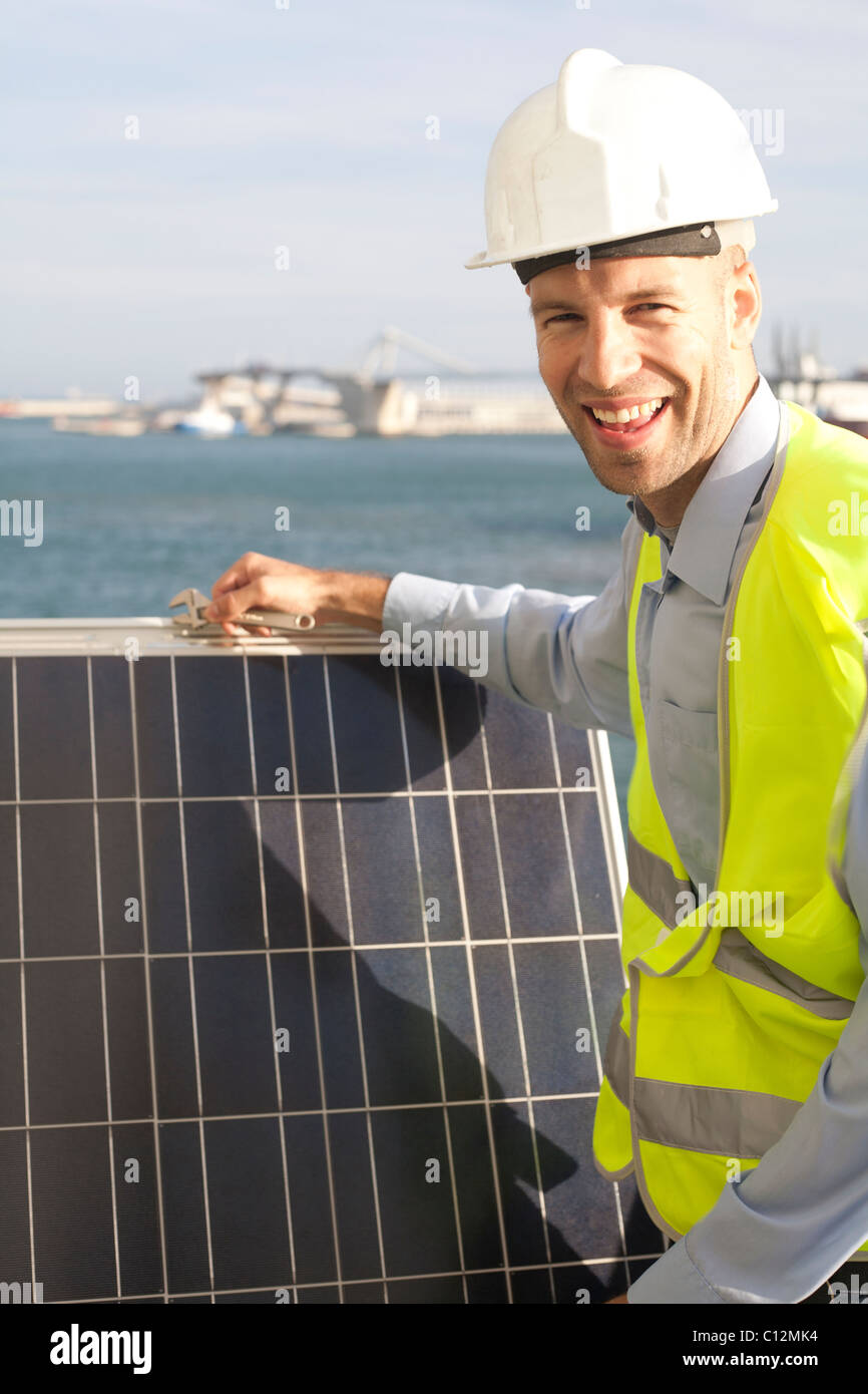 Solar energy man with a solar panel Stock Photo - Alamy