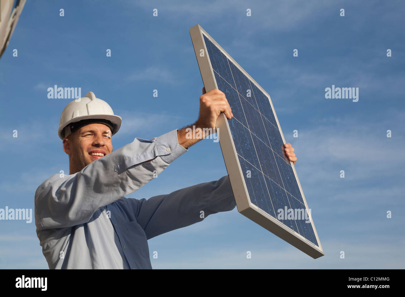 Solar energy man with a solar panel Stock Photo - Alamy