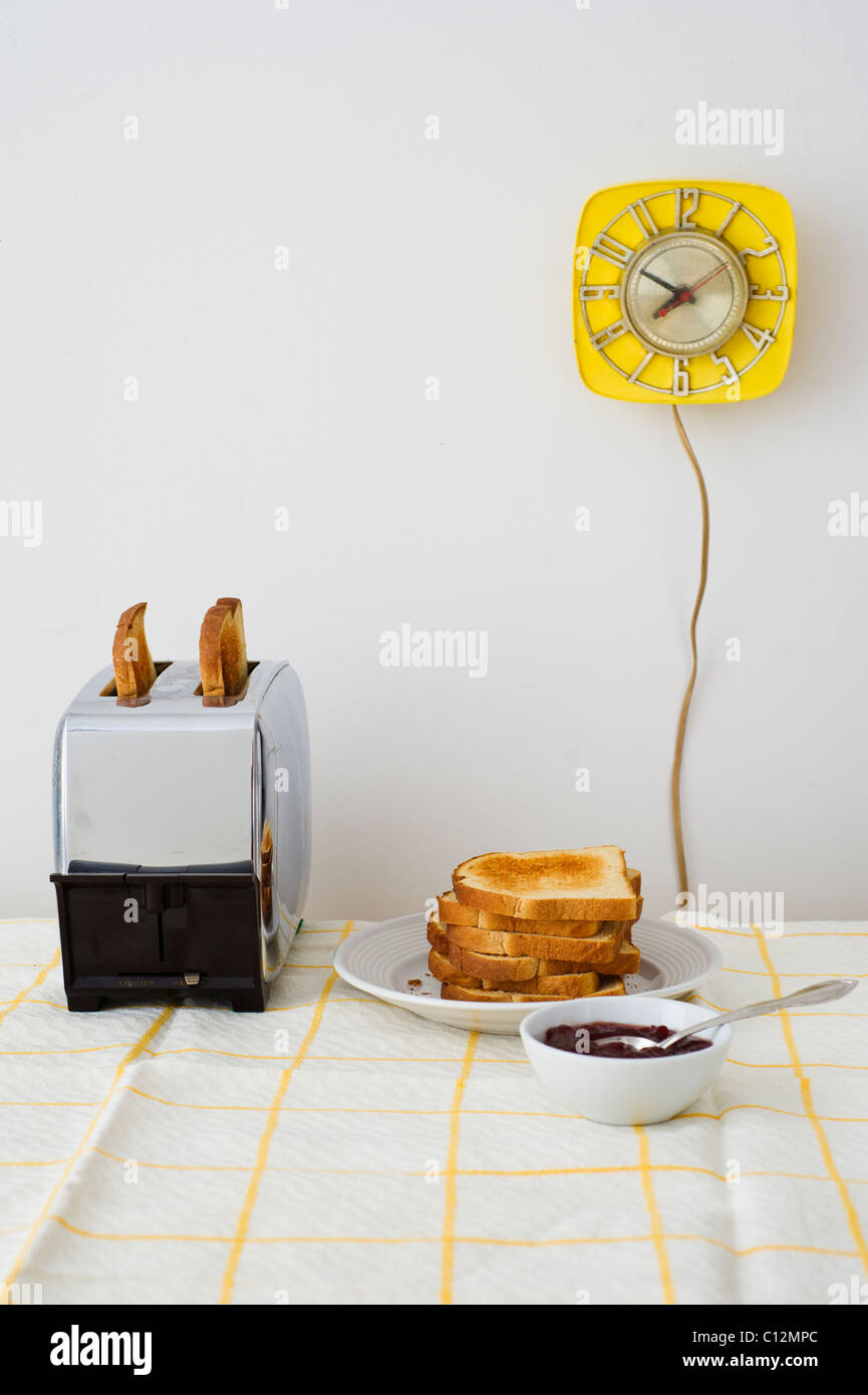 Toast in toaster on breakfast table Stock Photo - Alamy