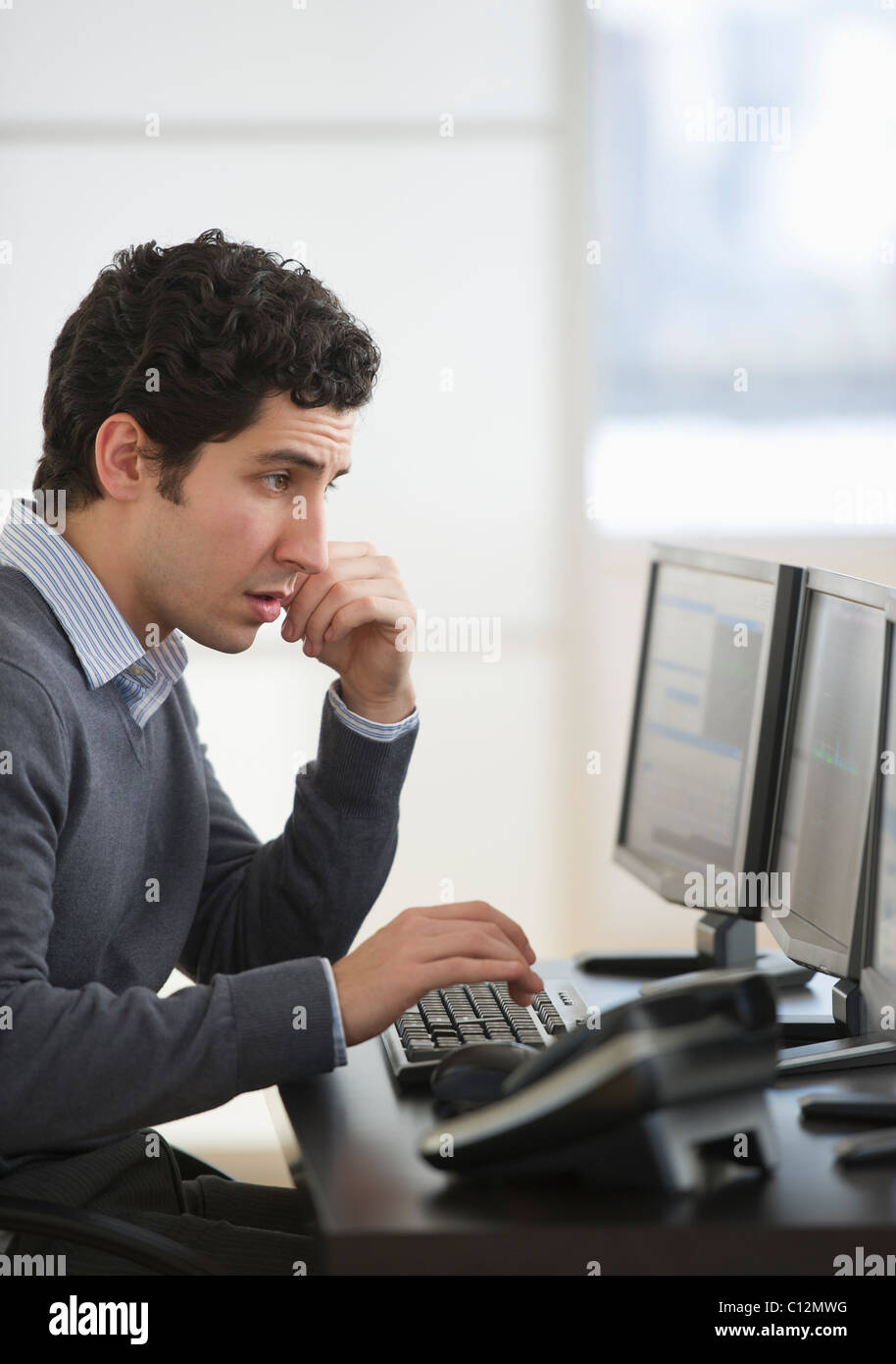USA, New Jersey, Jersey City, business man using computer in office ...