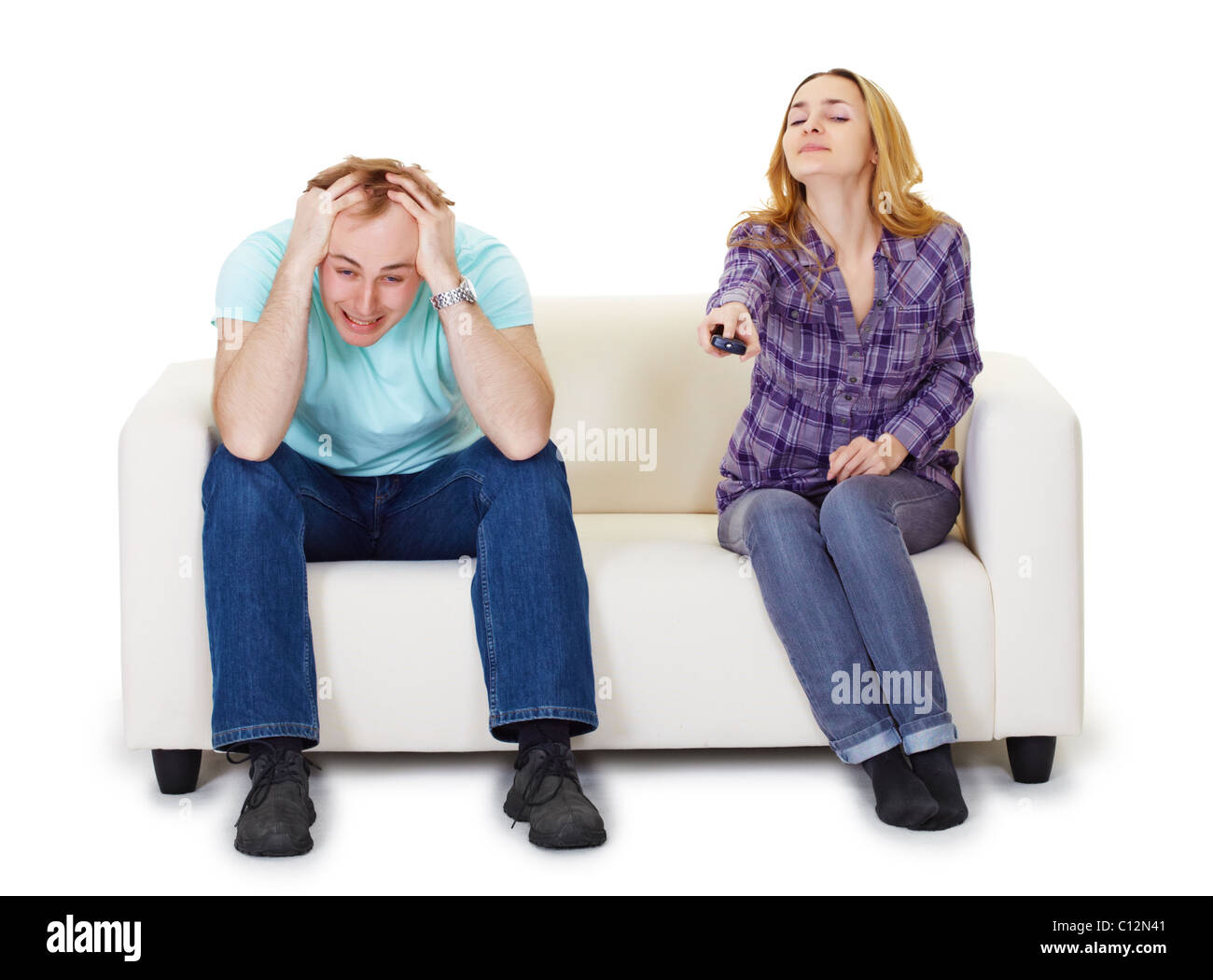 Nervous husband and wife sitting on the couch watching TV isolated on ...