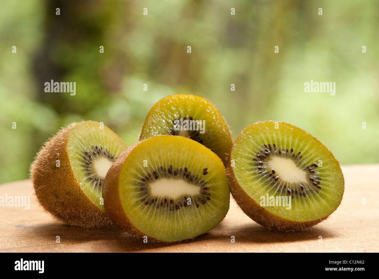 fresh sliced kiwi fruit against natural green background Stock Photo ...