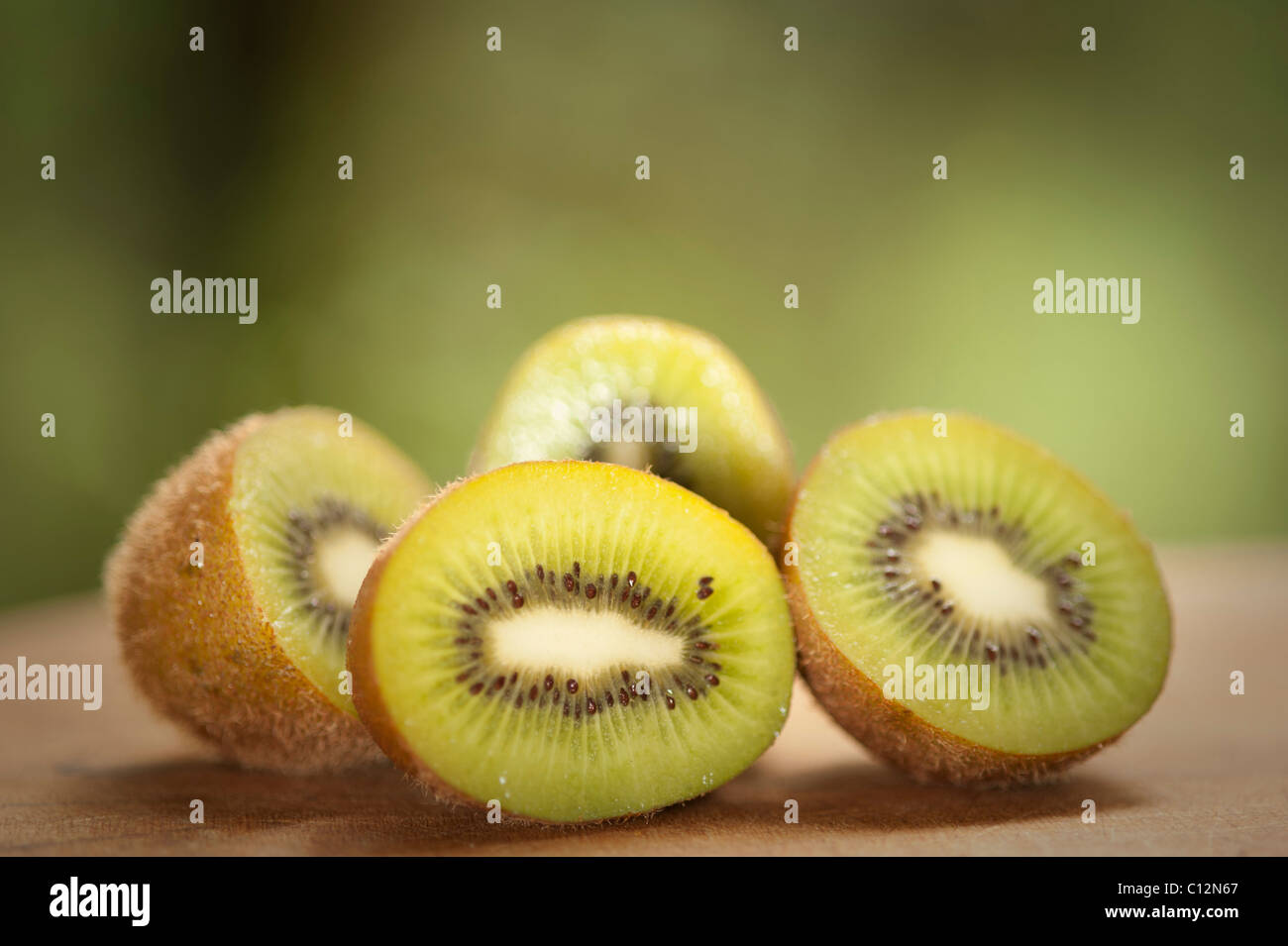 fresh sliced kiwi fruit against natural green background Stock Photo ...