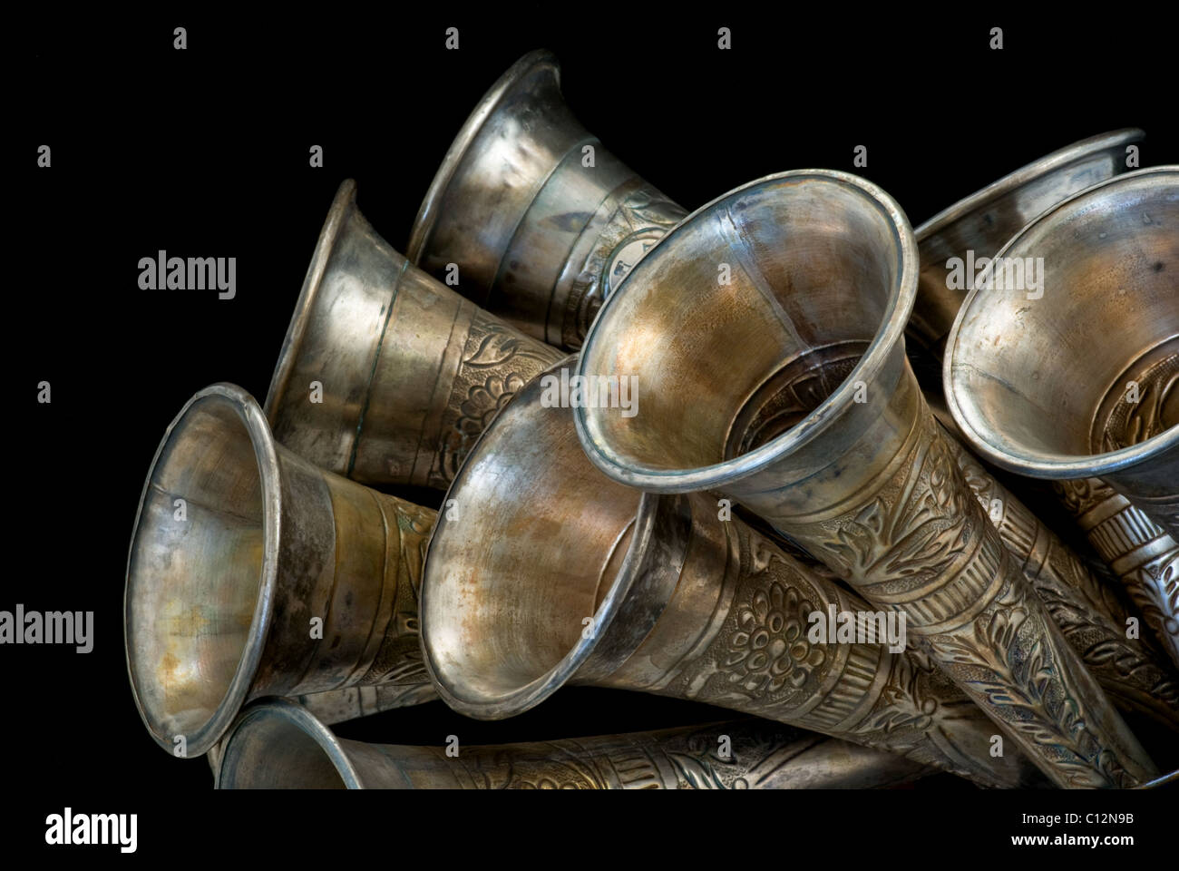 Eight metal fireman horns pointed out and upward as if shouting on a ...