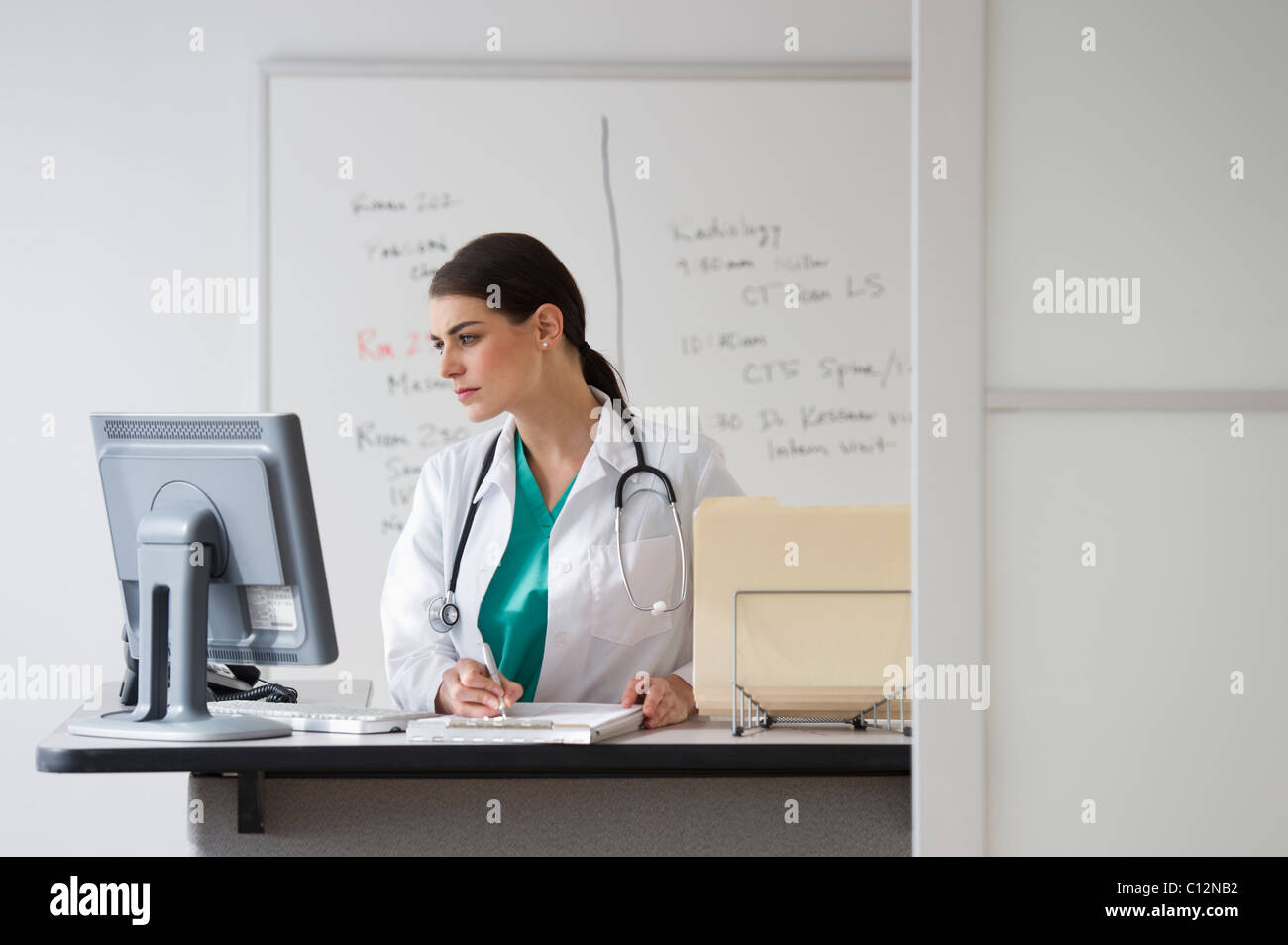 USA, New Jersey, Jersey City, Young female doctor working in office ...