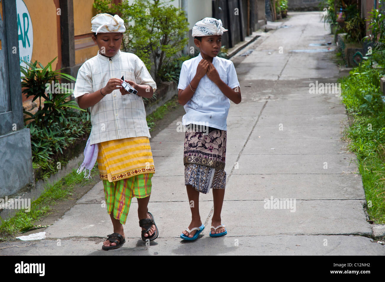 Two young Balinese boys on their way to a temple festival in Padang Bai ...