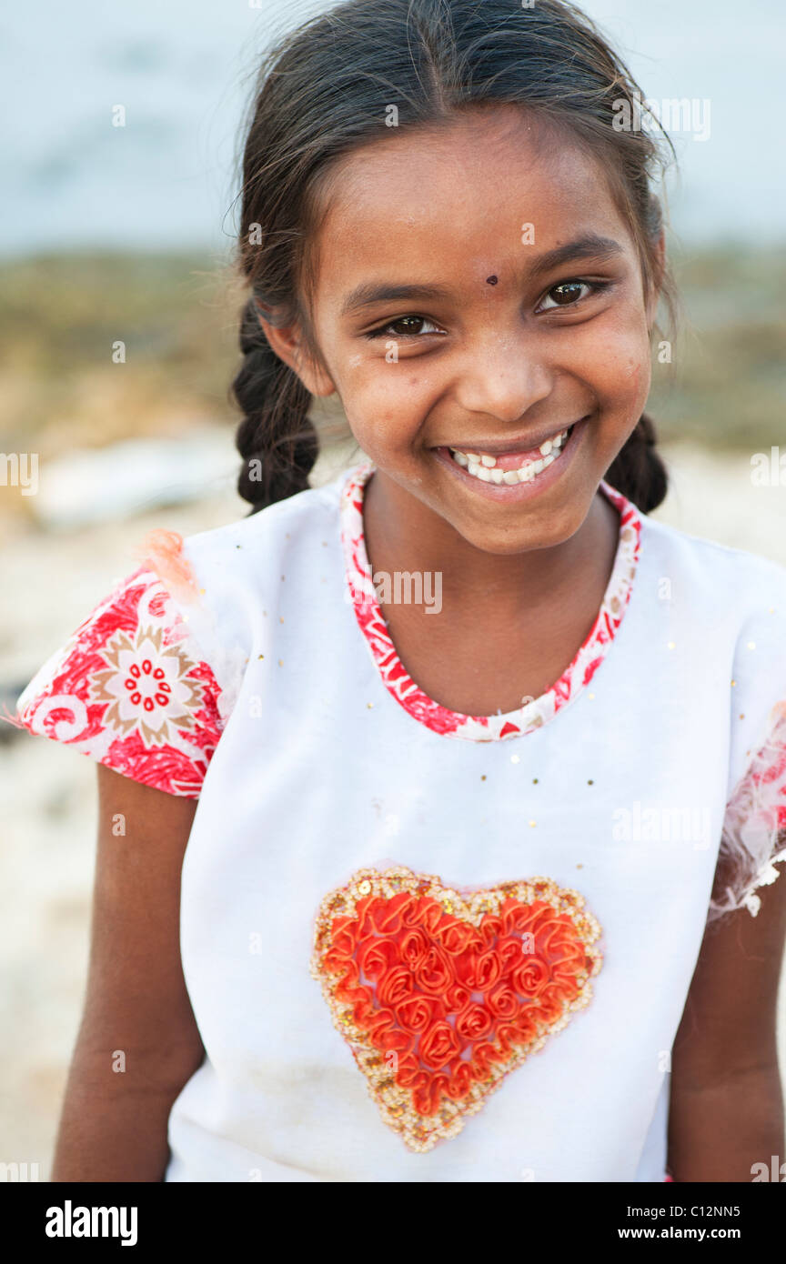 Smiling happy Indian village girl with a heart on her t-shirt. Andhra ...