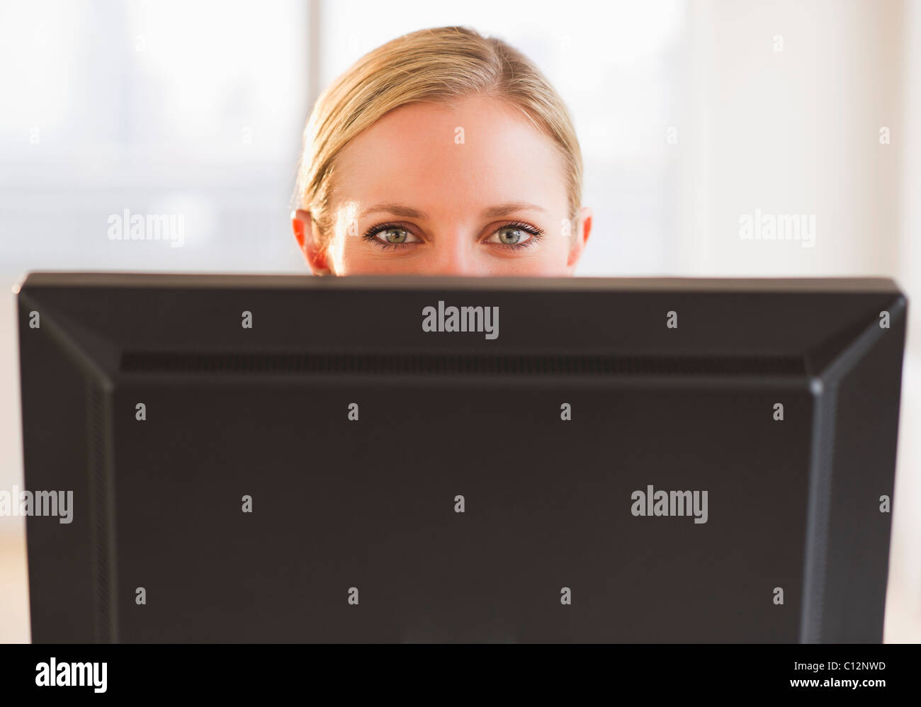 USA, New Jersey, Jersey City, businesswoman peeking from behind ...