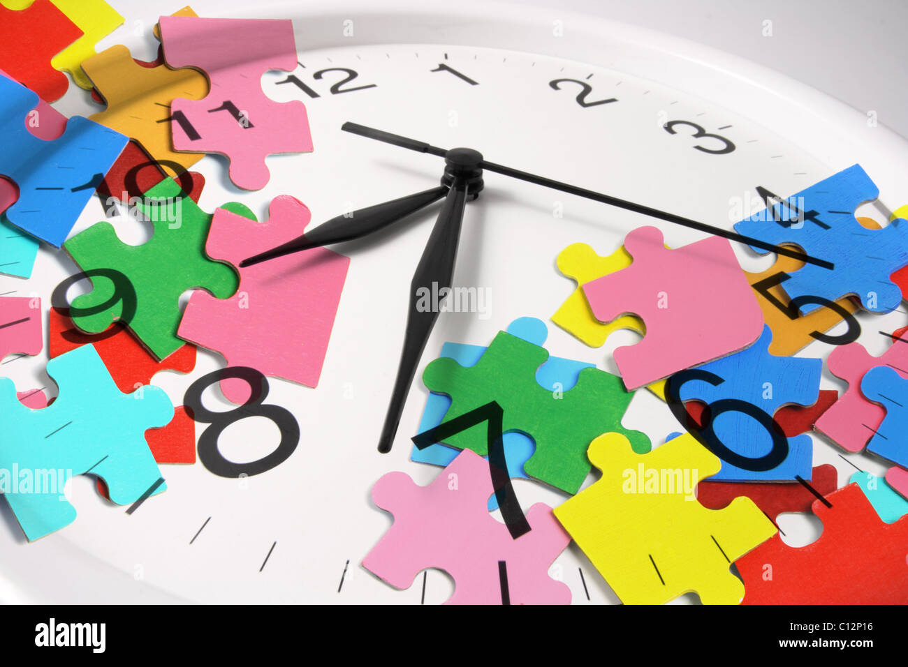 Clock and Jigsaw Puzzle Pieces Stock Photo - Alamy