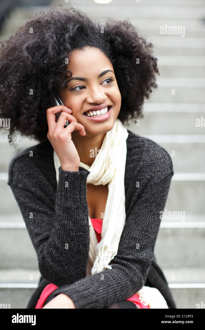 USA, Washington State, Seattle, young woman sitting on steps and ...