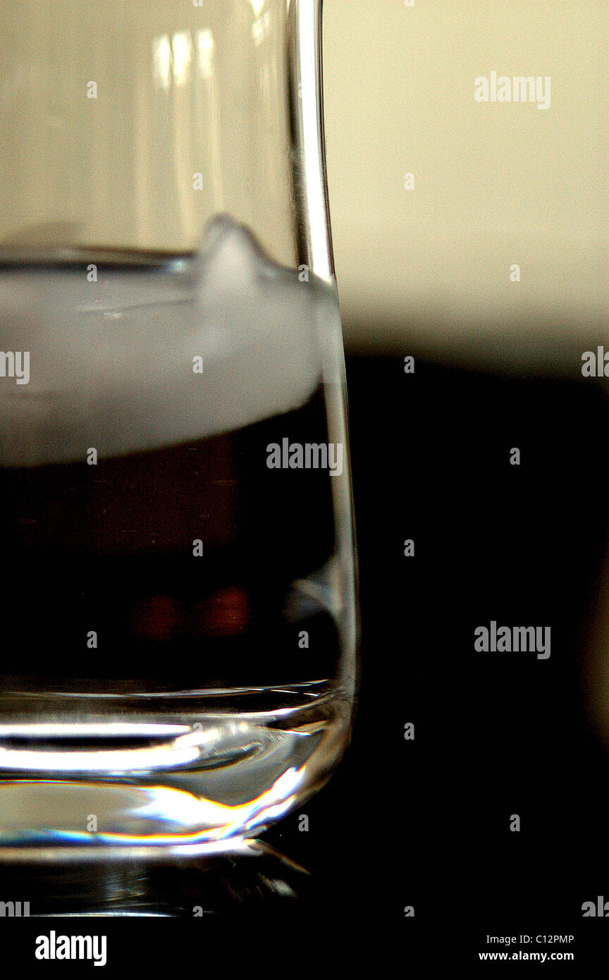 Liquid alcohol in the bottom of a glass Stock Photo - Alamy