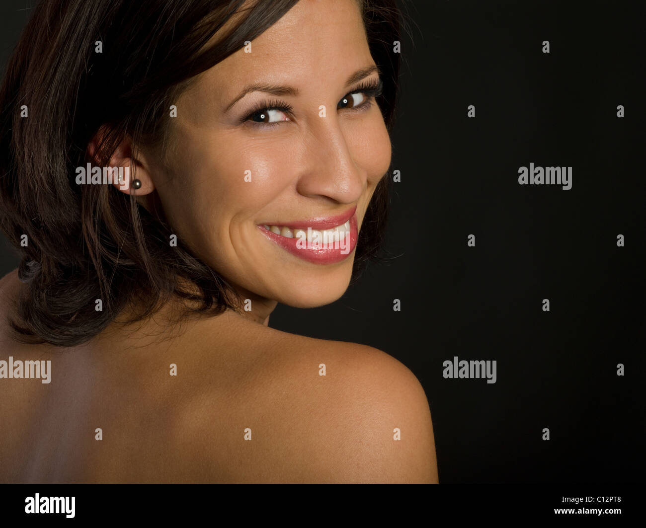 Beautiful woman looking over her shoulder into the camera Stock Photo ...