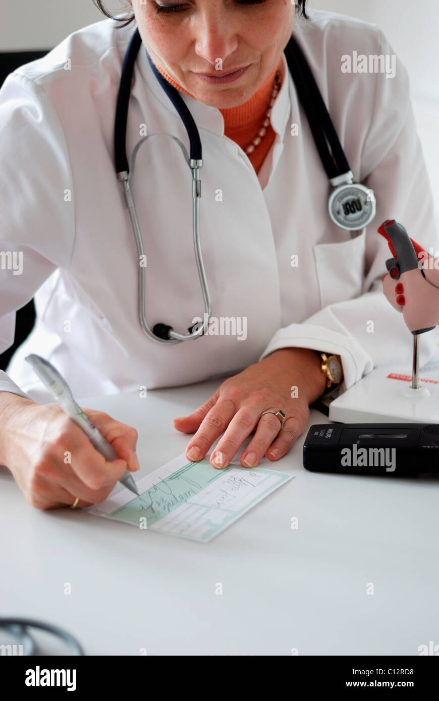 Doctor writing a prescription Stock Photo - Alamy