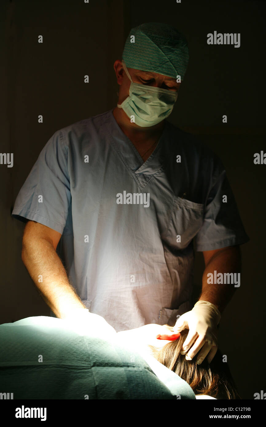 Surgeon With Patients Head Stock Photo - Alamy