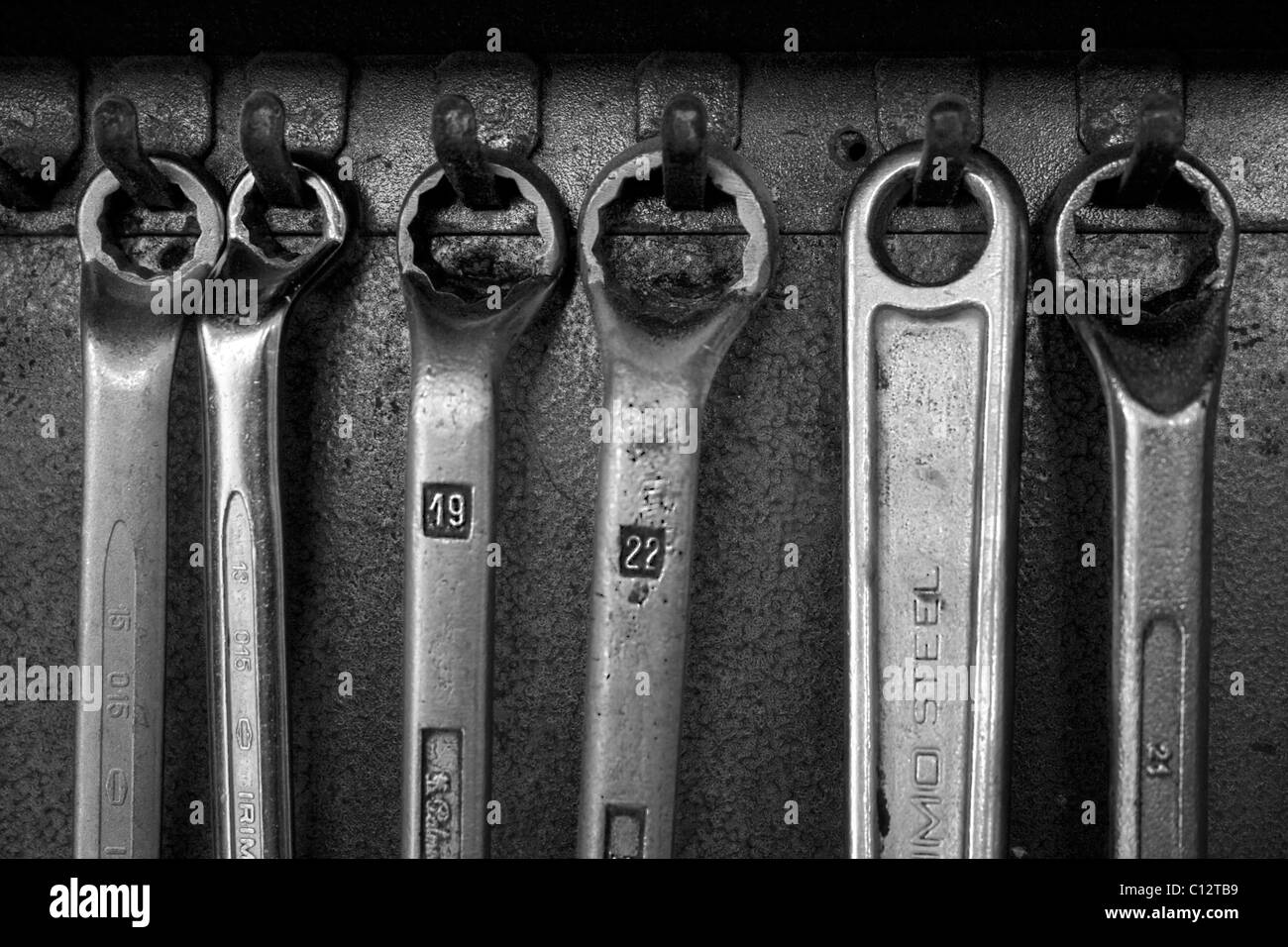 Metal spanners hanging in workshop Stock Photo - Alamy