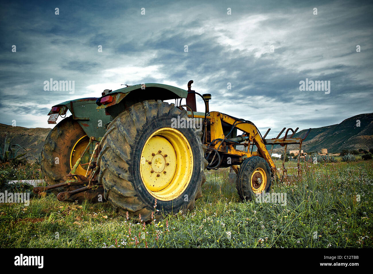 Tractor parked in rural landscape Stock Photo - Alamy
