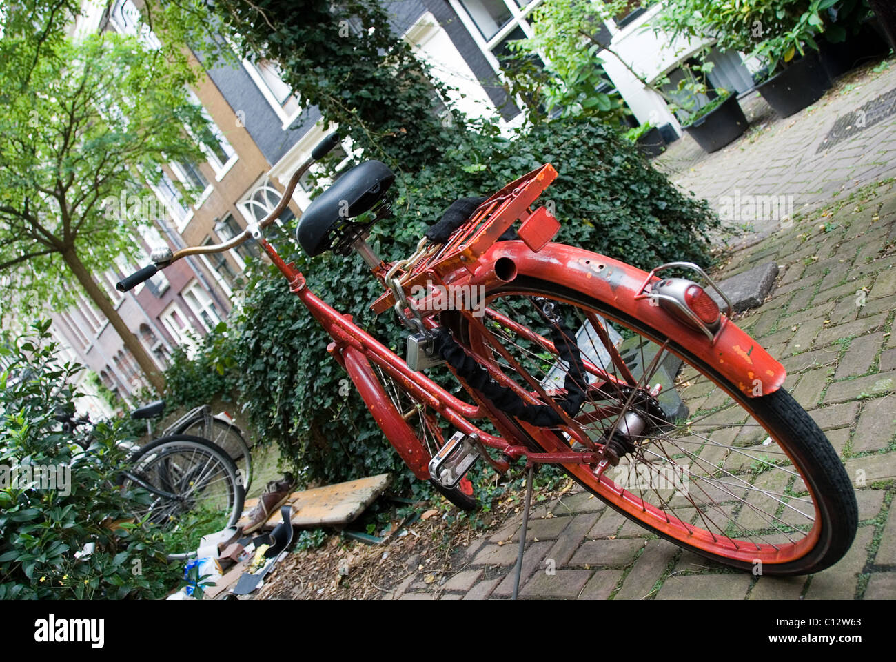 Red bicycle under tree in amsterdam hi-res stock photography and images ...