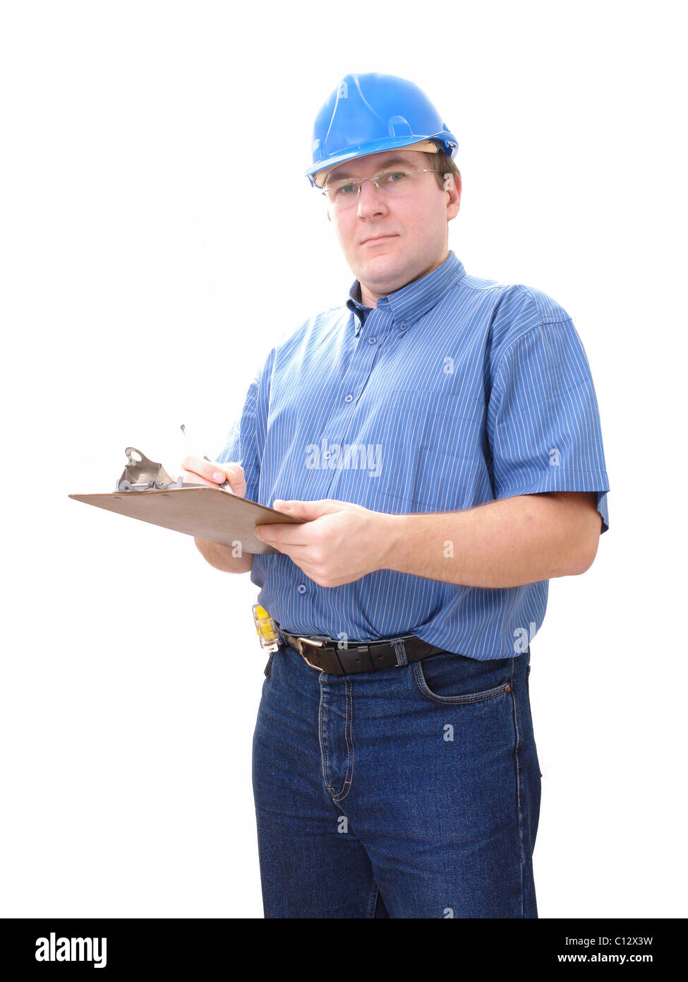 Construction site manager wearing blue helmet making notes on notepad ...