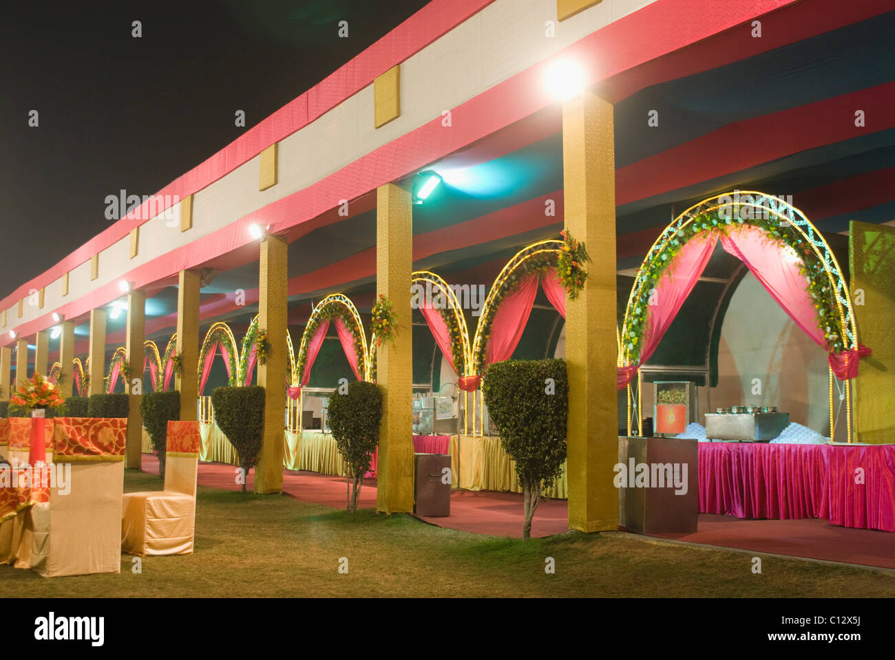 Decorated wedding tent lit up at night Stock Photo - Alamy