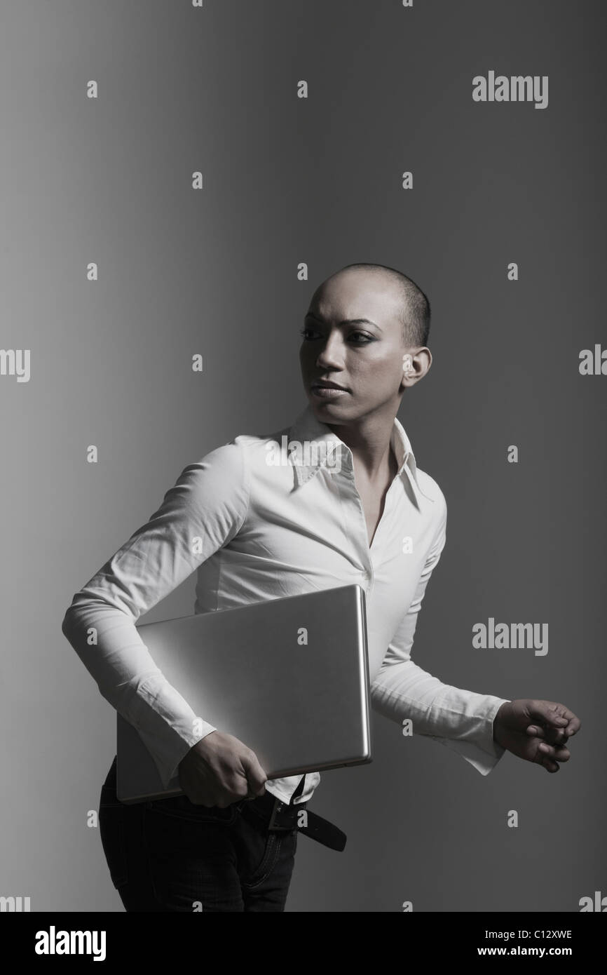 Gay man carrying a laptop Stock Photo - Alamy