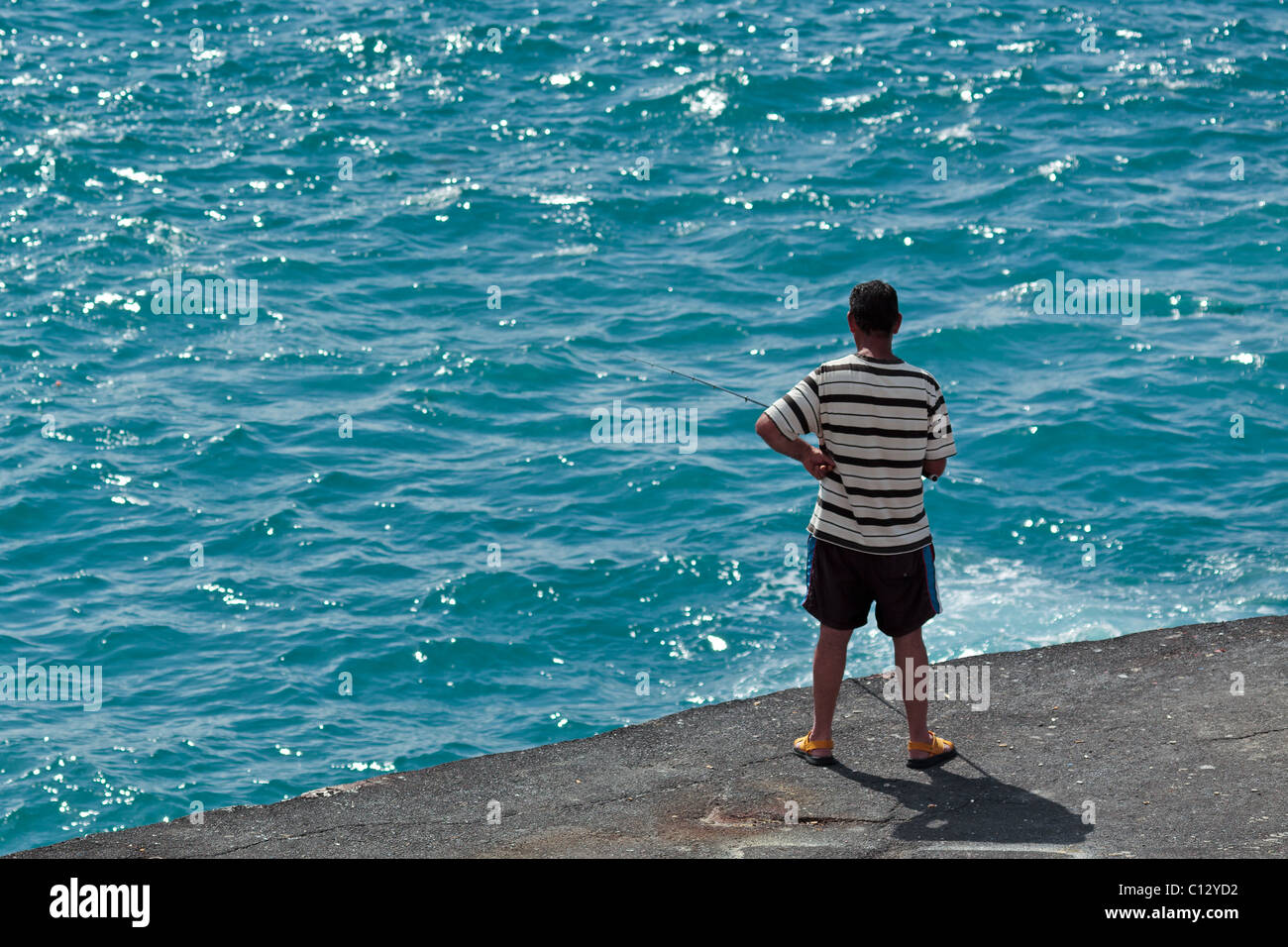 Man sea fishing Stock Photo - Alamy