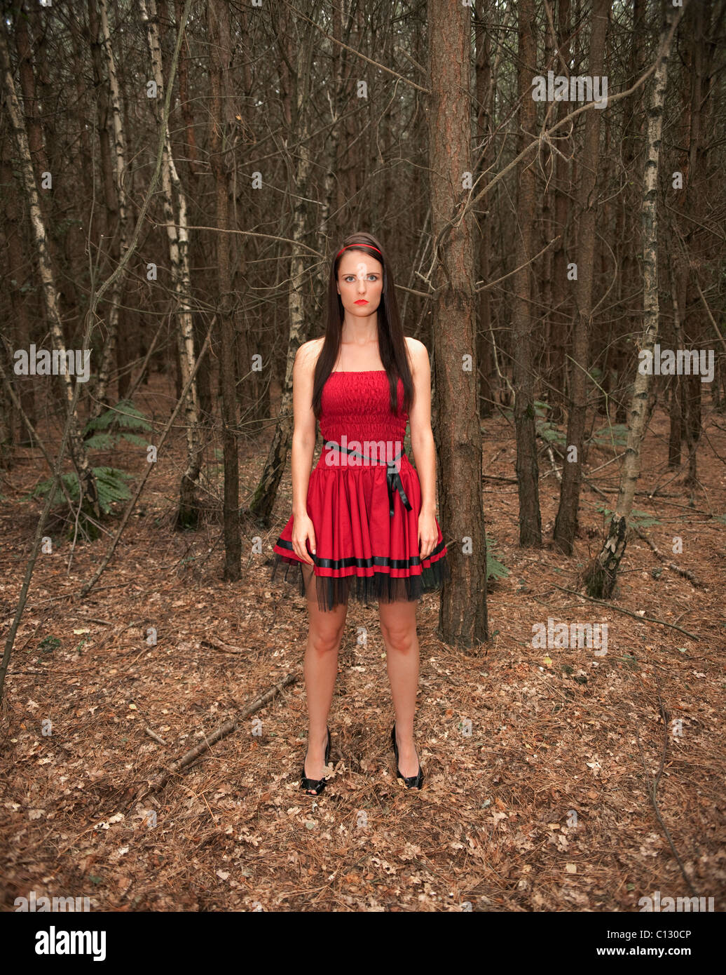young woman in red dress in a forest Stock Photo - Alamy